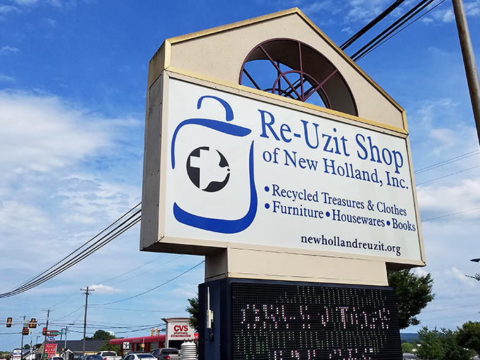 Re-Uzit Shop's blue and cream exterior sits quietly, like a humble librarian who knows all the best stories are waiting inside.