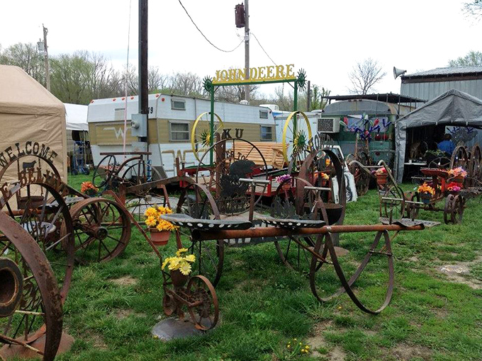Rusted farm implements transformed into garden art&mdash;where Kansas agricultural history meets modern yard decoration in a beautiful rusty symphony.