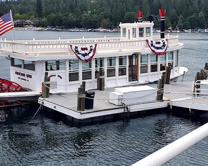 The Arrowhead Queen Tour Boat stands ready for duty, decked in patriotic bunting like a floating Fourth of July celebration.