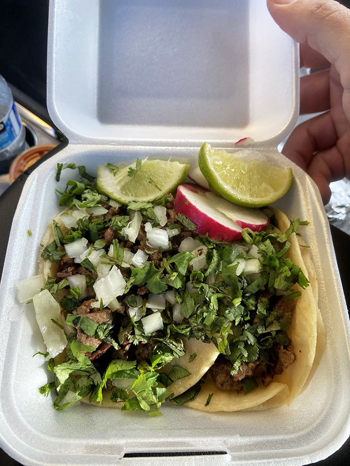 These tacos, nestled in their to-go container with lime wedges standing by, are about to make someone's day significantly better than it was five minutes ago.