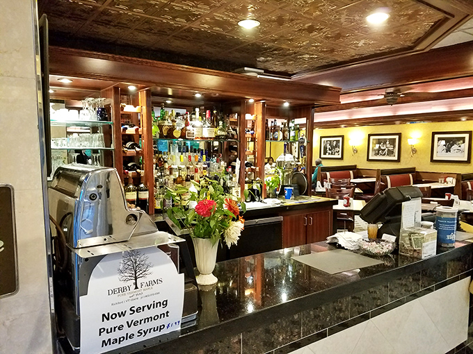 The bar area gleams with well-polished hospitality, promising everything from morning mimosas to evening nightcaps. Those fresh flowers? A lovely touch of hominess.