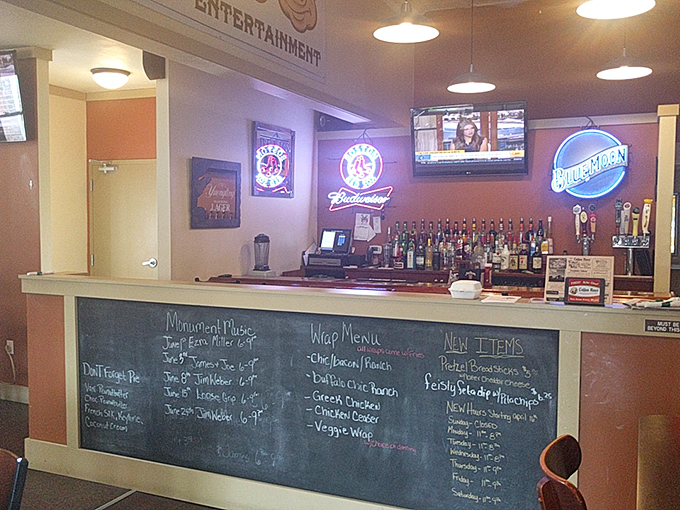 The bar area serves as command central for craft beer operations, where decisions about which local brew pairs best with pizza are treated with appropriate seriousness. 