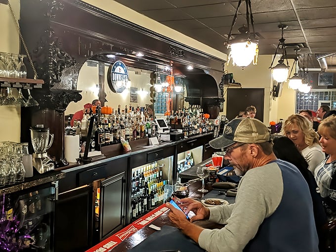 The bar area hums with conversation and clinking glasses. A perfect perch for solo diners or those waiting for their table.