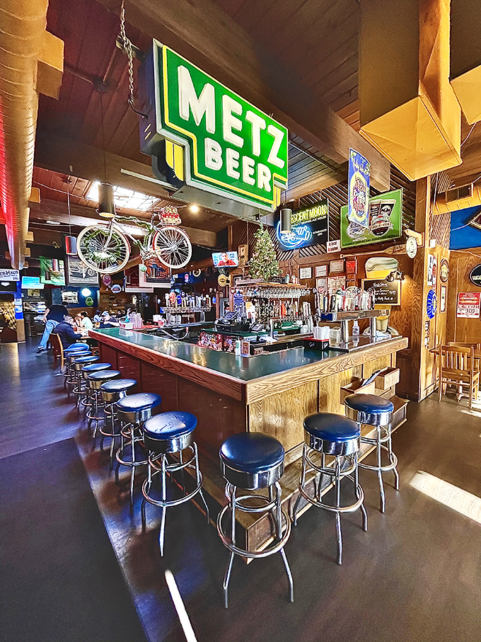 The bar area glows with neon promise, where beer taps stand ready like soldiers awaiting their call to refreshment duty.