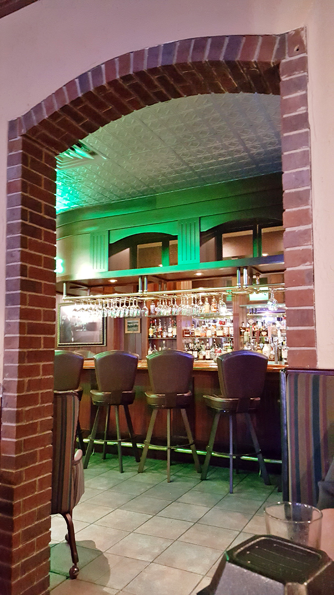 The bar area, framed by that dramatic brick archway, beckons with the promise of well-crafted cocktails and lively conversation.