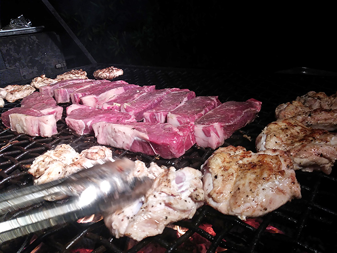 Watch the magic happen as steaks sizzle over open flames, turning raw potential into pure perfection. 