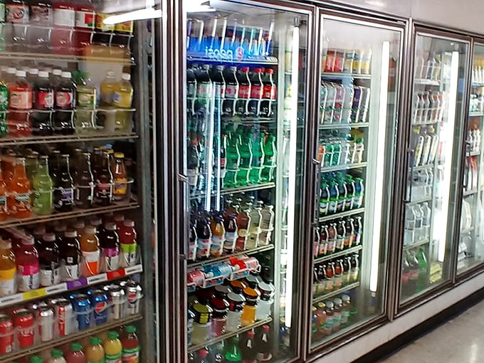 The beverage cooler—a wall of liquid possibilities standing ready to complement whatever masterpiece you've chosen from the menu.