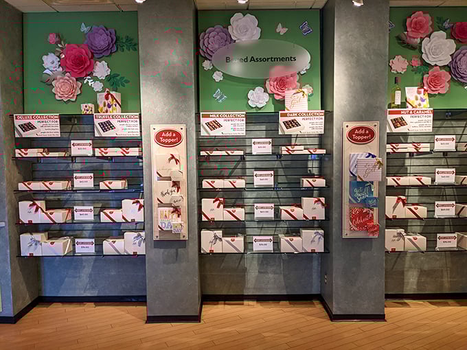 Boxed assortments arranged like a chocolate library, with each shelf offering different volumes of sweetness bound in elegant packaging.