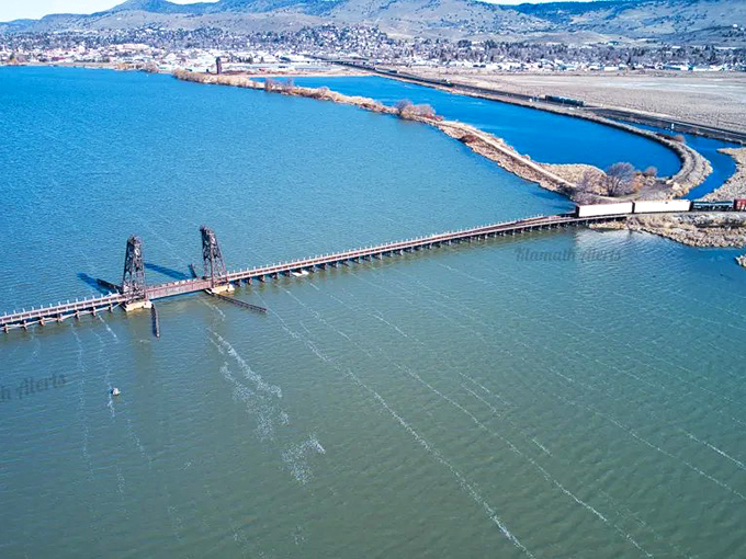 The historic bridge spans across brilliant blue waters, connecting Klamath Falls' past to its present while offering spectacular views in every direction.