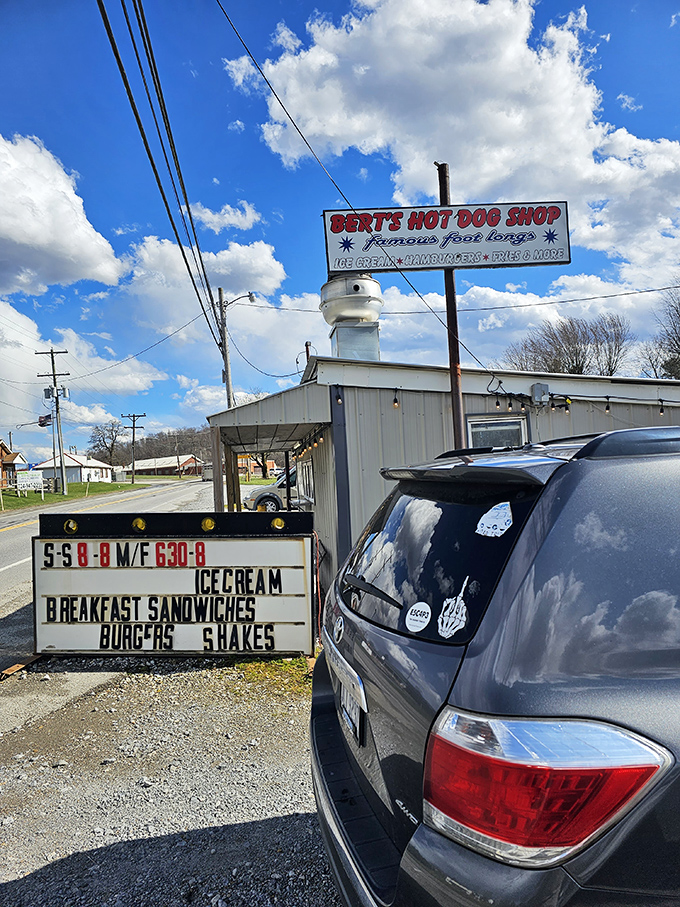 The sign announces operating hours like a promise &ndash; these are the golden times when happiness is served in paper wrappers.