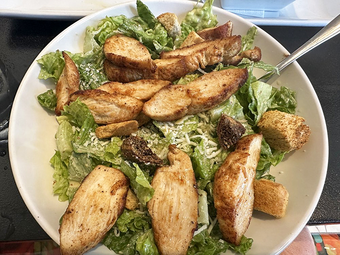 Caesar salad elevated beyond the ordinary&mdash;crisp romaine embraced by creamy dressing, crowned with perfectly seasoned chicken that means business.