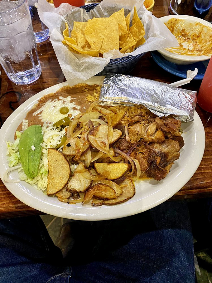 Carnitas with all the fixings spread across the plate like a treasure map where X marks every delicious spot worth exploring.