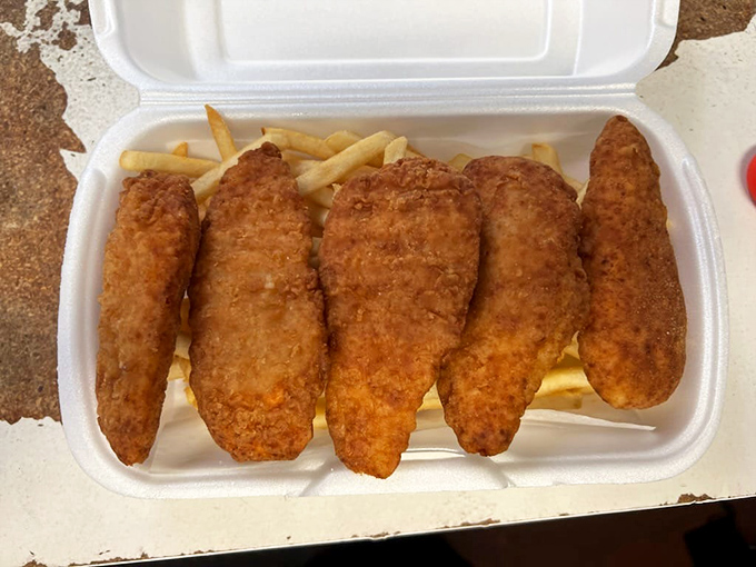 Golden-fried chicken strips nestled beside fries&mdash;the comfort food combo that transcends age, class, and culinary pretension. 