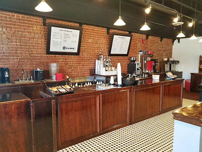 The coffee counter: where morning ambitions meet afternoon cravings against a backdrop of exposed brick that's seen it all.