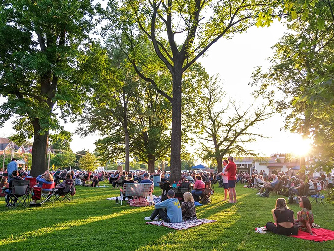 Summer evenings in the park bring the community together for concerts and picnics, where strangers become neighbors under the golden Missouri sunset.