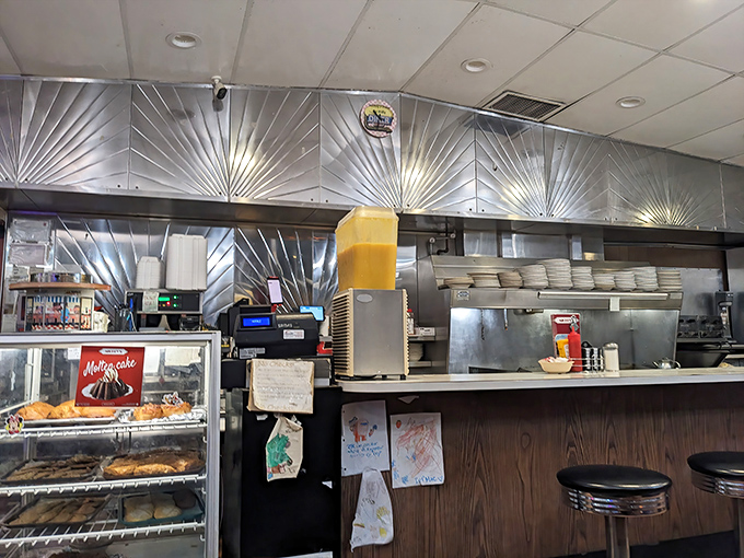 That stainless steel backsplash has witnessed more Minnesota history than most museums, all while reflecting the glory of sizzling bacon.