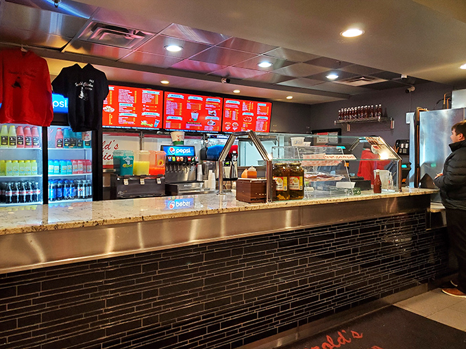 The counter where dreams come true. Behind that glass lies a kitchen choreography that's been perfected over decades of chicken-frying excellence.