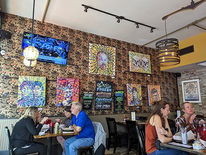 Local art adorns floral wallpaper, creating that perfect New Orleans vibe where tradition and eccentricity aren't just neighbors&mdash;they're roommates who get along famously.