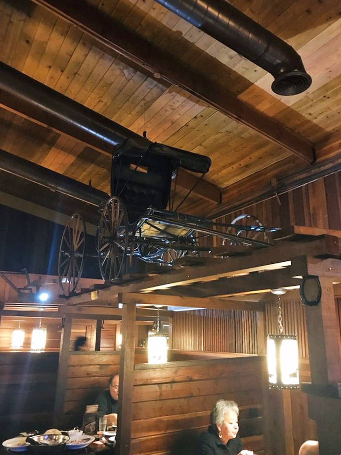 An antique carriage suspended from wooden beams&mdash;because nothing says "serious about meat" like decorating with transportation from the 1800s.