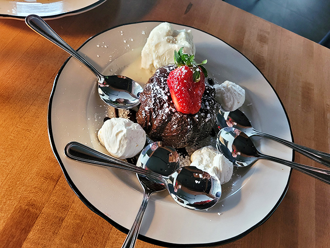 Chocolate decadence surrounded by whipped cream islands &ndash; a dessert that demands multiple spoons and zero conversation until it's gone.