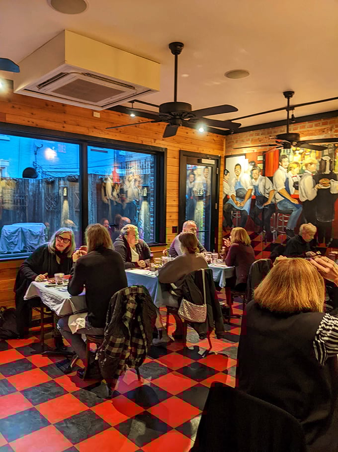 The checkered floor provides a racing flag backdrop as diners speed toward flavor victory, fueled by hardwood-grilled perfection.
