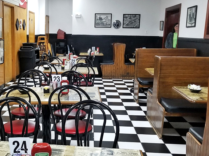 Classic black and white checkered floors anchor wooden booths where countless stories have been shared over countless cups of coffee.