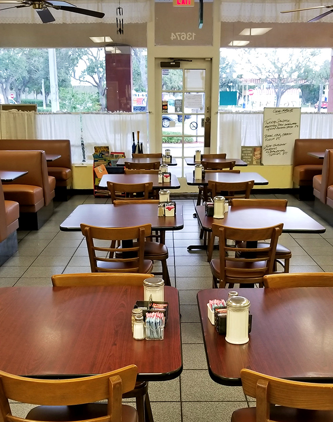 Empty tables that won't stay that way for long. Morning light streams in through those windows like it's auditioning for a breakfast commercial. 