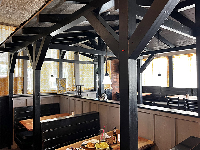 Wooden beams create intimate dining zones that feel like your own private Idaho. Sunshine streams through windows like nature's spotlight on your meal.