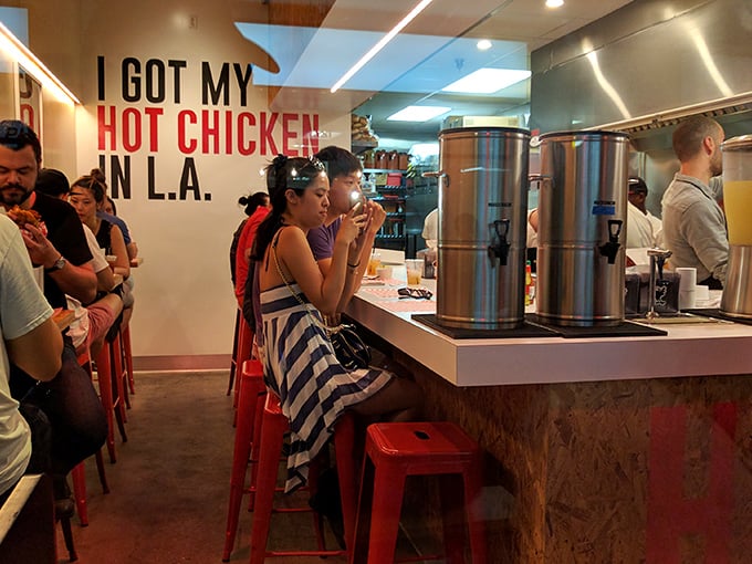 Where pilgrims come to worship at the altar of spice. The sign isn't just decor—it's the restaurant's mission statement.