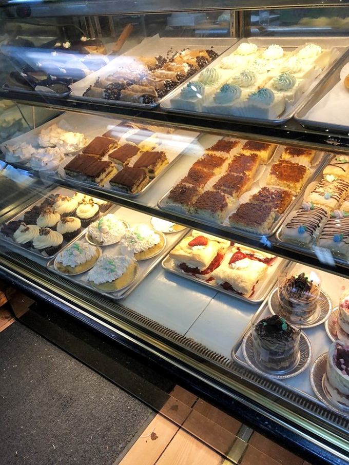 The bakery case&mdash;where dreams and calories live in perfect harmony. Each tray holds the potential to turn a bad day completely around.