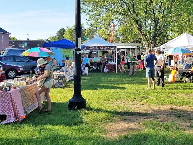 The Farmers & Artists Market creates a colorful tapestry of local creativity, where purple mums frame conversations between makers and admirers.
