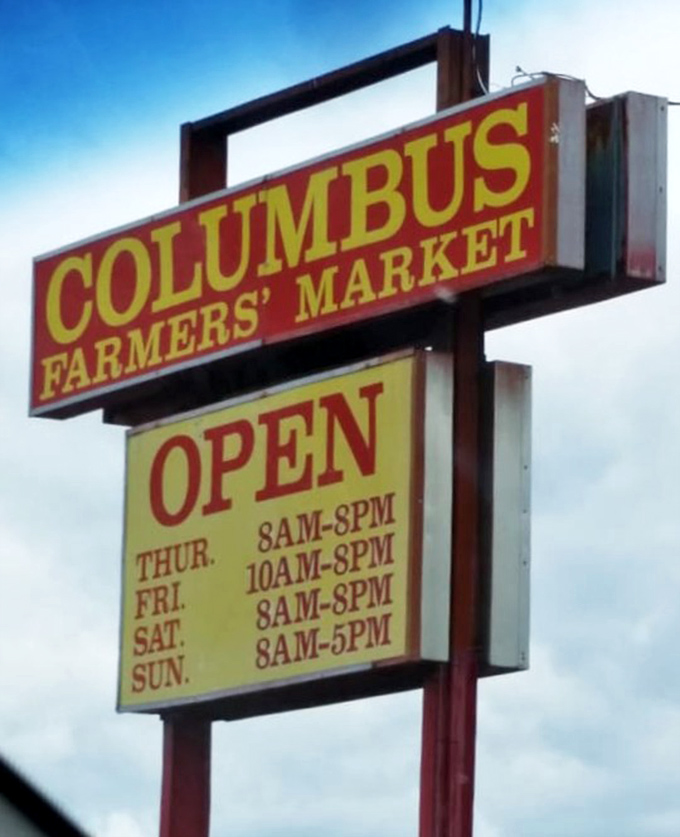 The market's sign announces operating hours with no-nonsense clarity. Like a friendly neighbor saying, "Come over Thursday through Sunday, we'll leave the light on."
