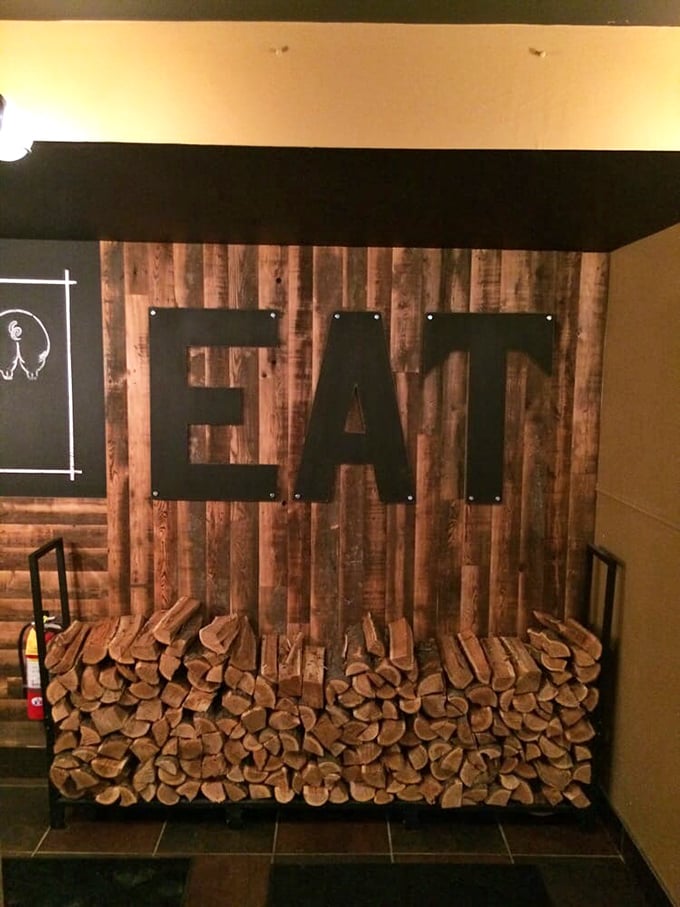 The "EAT" sign above stacked firewood isn't just decoration&mdash;it's the simplest instruction you'll ever happily follow.