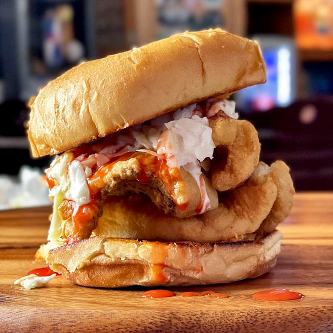 Sandwich architecture at its finest&mdash;crispy, golden flounder stacked with creamy slaw and sauce. A tower of flavor that requires both hands and napkins.