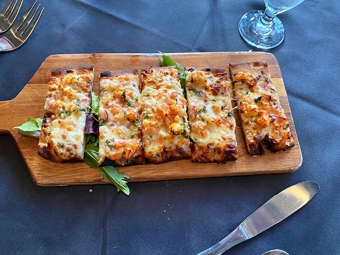 This flatbread isn't just pizza's sophisticated cousin; it's a crispy, cheesy canvas of culinary creativity that demands to be shared (reluctantly).