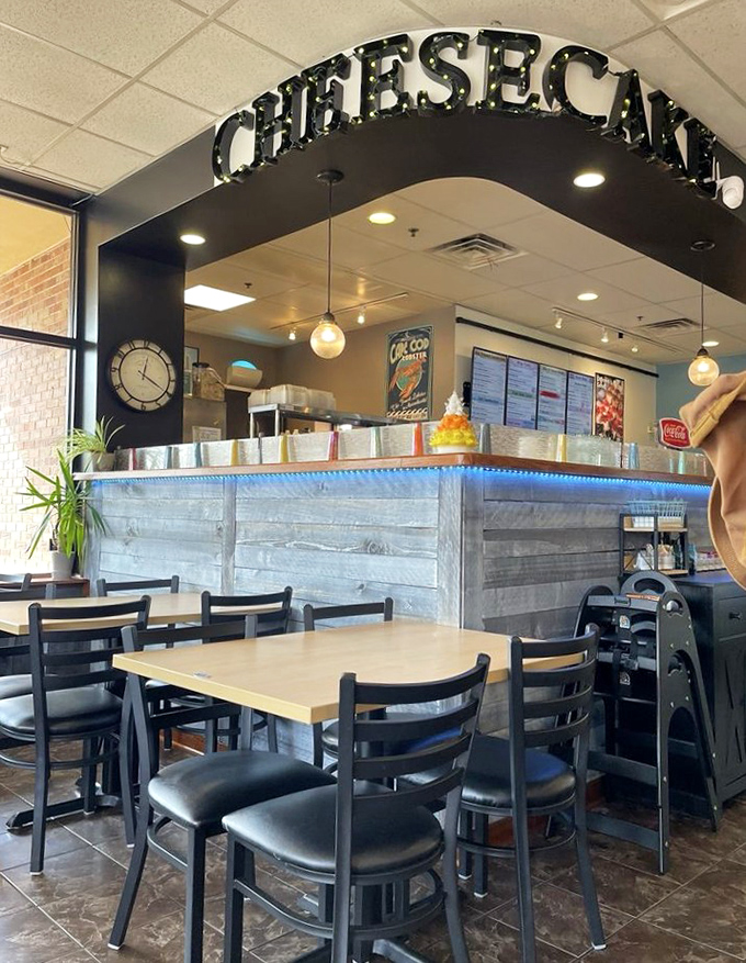 The illuminated "CHEESECAKE" sign serves as both decoration and a beacon of hope for the dessert-deprived masses.