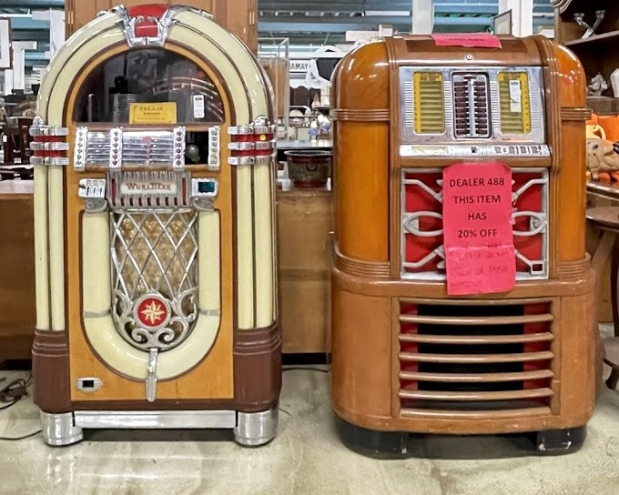 Jukeboxes standing like sentinels of simpler times, when dropping a nickel meant three minutes of musical escape.