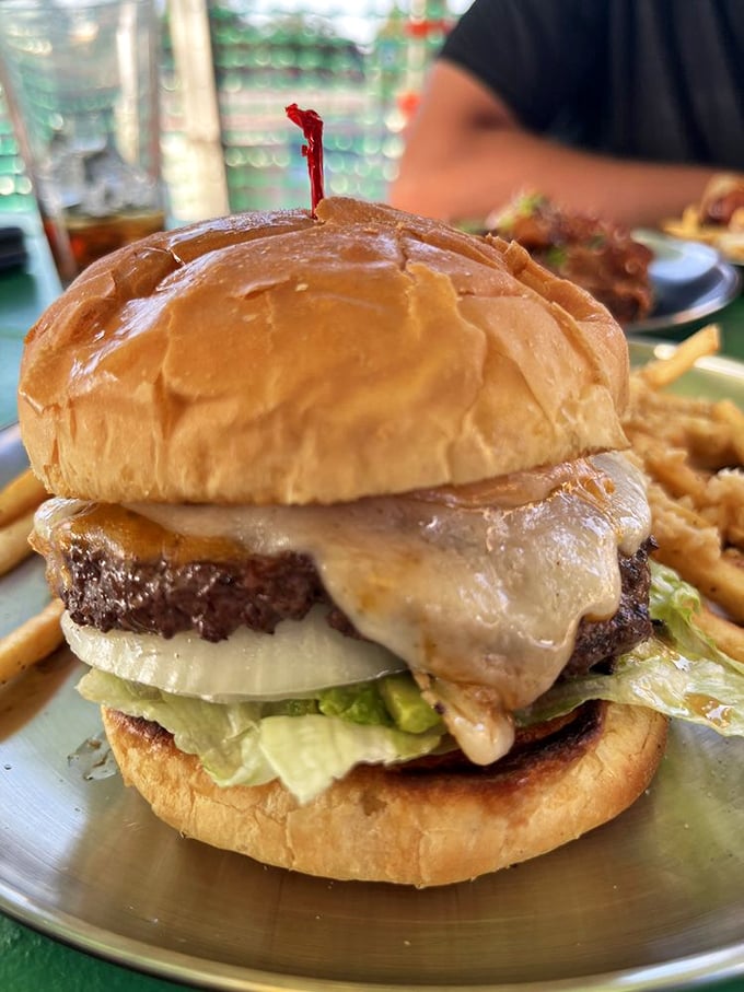 This isn't just a burger &ndash; it's architecture. The melted cheese cascading down the sides creates a mouthwatering monument to beef.
