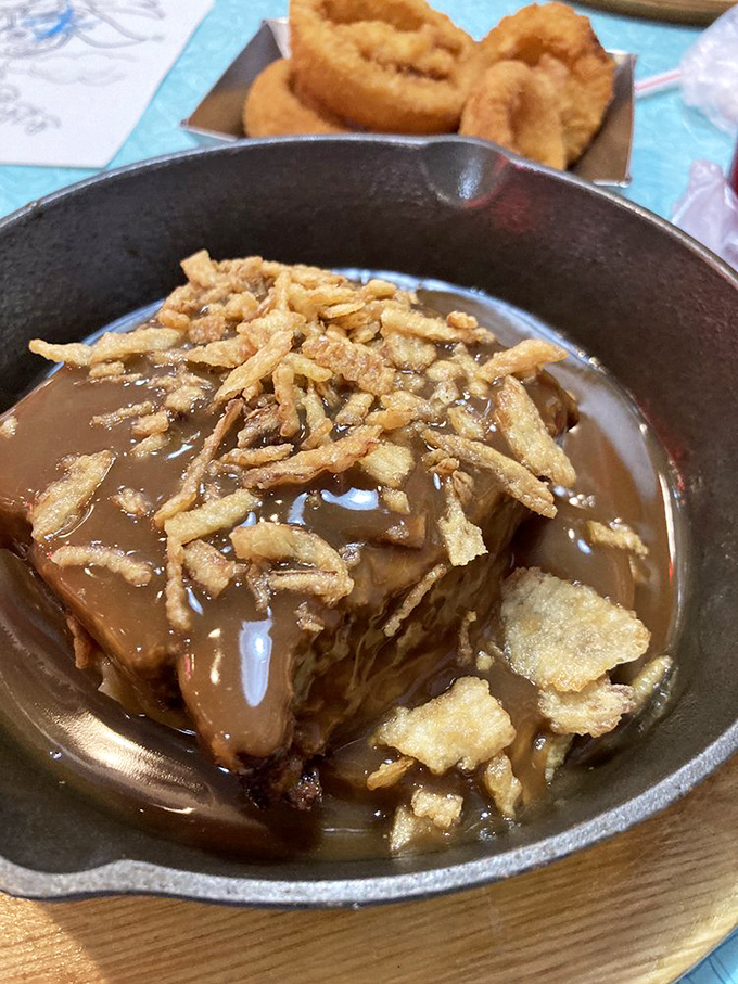 Meatloaf crowned with crispy onions and swimming in gravy&mdash;comfort food royalty that makes you want to hug the chef and steal the recipe.
