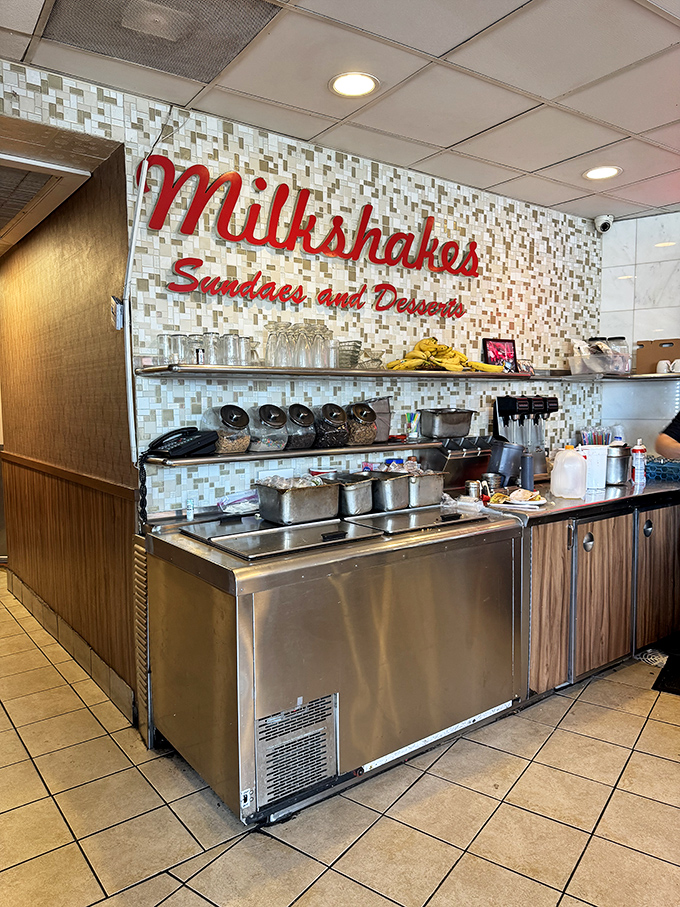 The milkshake station&mdash;where dairy dreams come true. That retro sign isn't just decoration; it's a promise of creamy happiness to come.