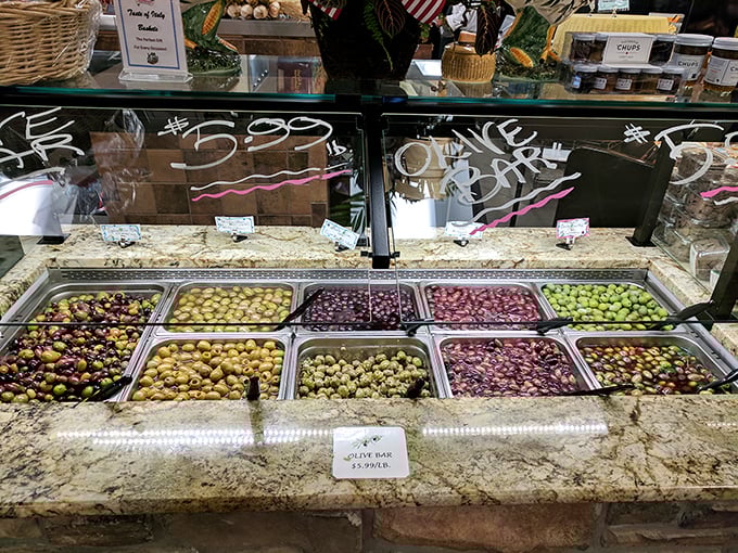 The olive bar—a Mediterranean rainbow where each briny morsel tells a story of sun-drenched groves and centuries-old traditions.