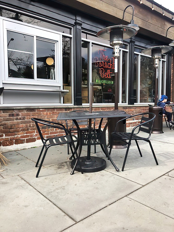 Even the outdoor seating has a story to tell. That neon sign glowing through the window promises delicious secrets waiting inside.