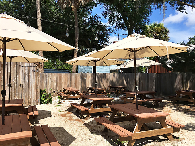 Picnic tables and umbrellas create an oasis where time slows down just enough to savor every bite of that Cuban sandwich.