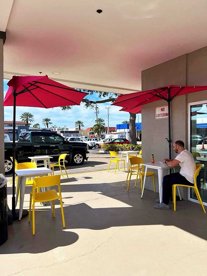 Sunshine, red umbrellas, and yellow chairs &ndash; the outdoor seating area where you can enjoy your pastry with a side of vitamin D.