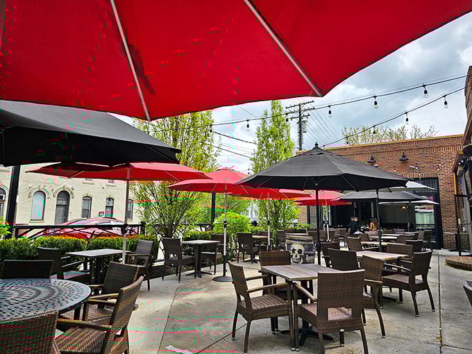 Red umbrellas pop against the Cleveland sky, creating an outdoor oasis where string lights promise good times will continue past sunset.