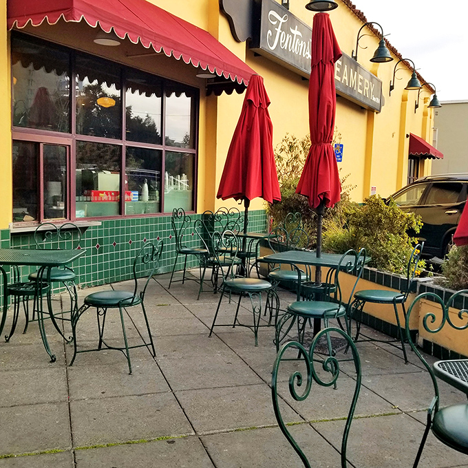 The outdoor patio offers a Mediterranean vibe with wrought iron chairs and red umbrellas—perfect for savoring that last bite.