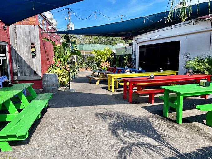 Picnic tables in primary colors that look like they were designed by a kindergartner with excellent taste. The perfect backdrop for serious BBQ business.