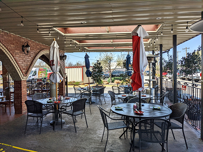 The outdoor patio offers al fresco dining with architectural charm. Those brick arches frame the space perfectly, creating a courtyard feel that enhances every bite.