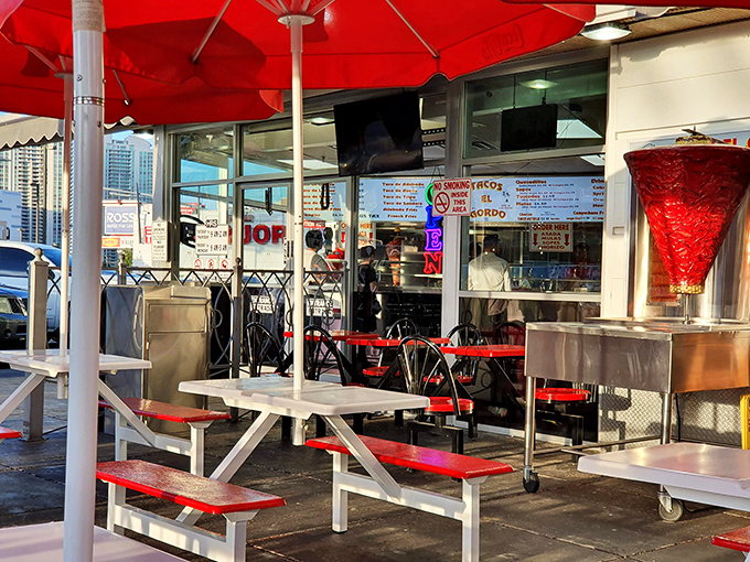 Outdoor seating where the Vegas sun and taco steam create a microclimate of pure contentment. Paradise found under a red umbrella.