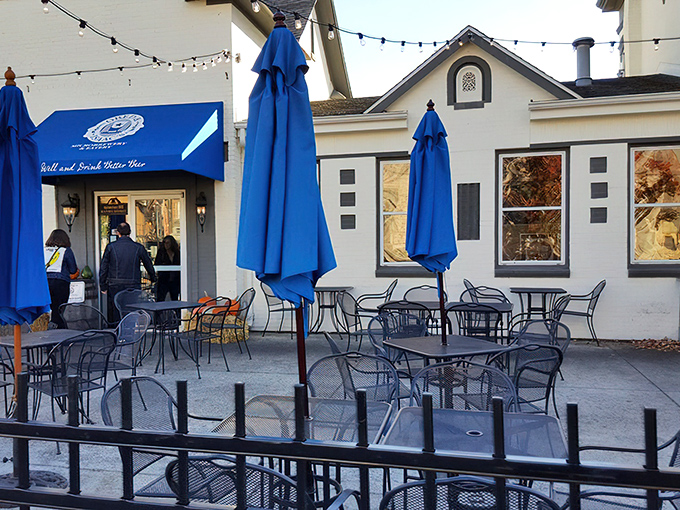The outdoor patio awaits with blue umbrellas standing sentinel, ready for those perfect Illinois days when the weather and your schedule finally cooperate.